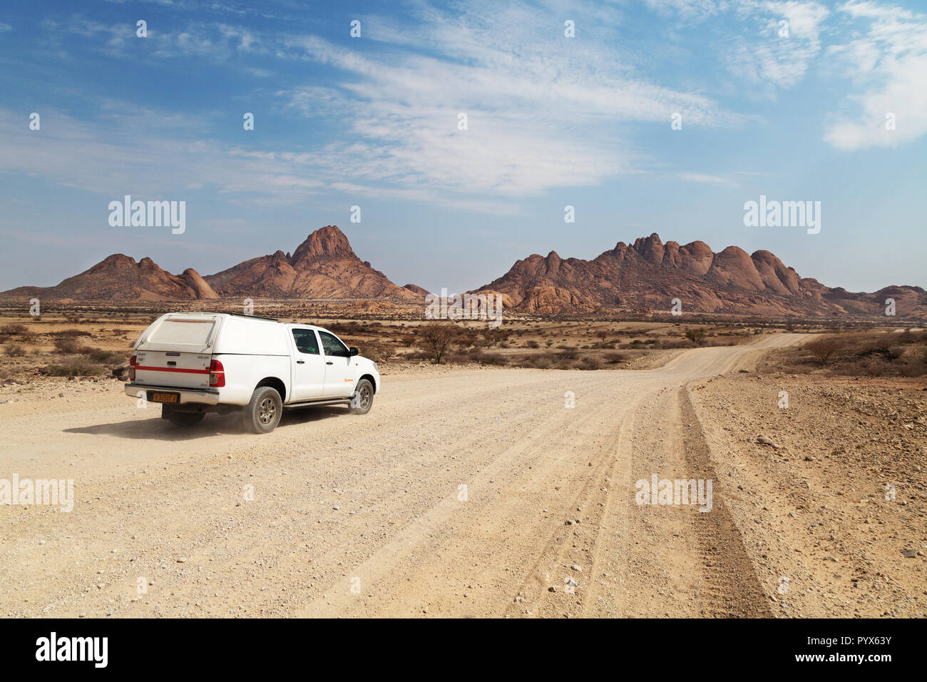 Namibia driving - A four by four car driving on gravel roads in ...