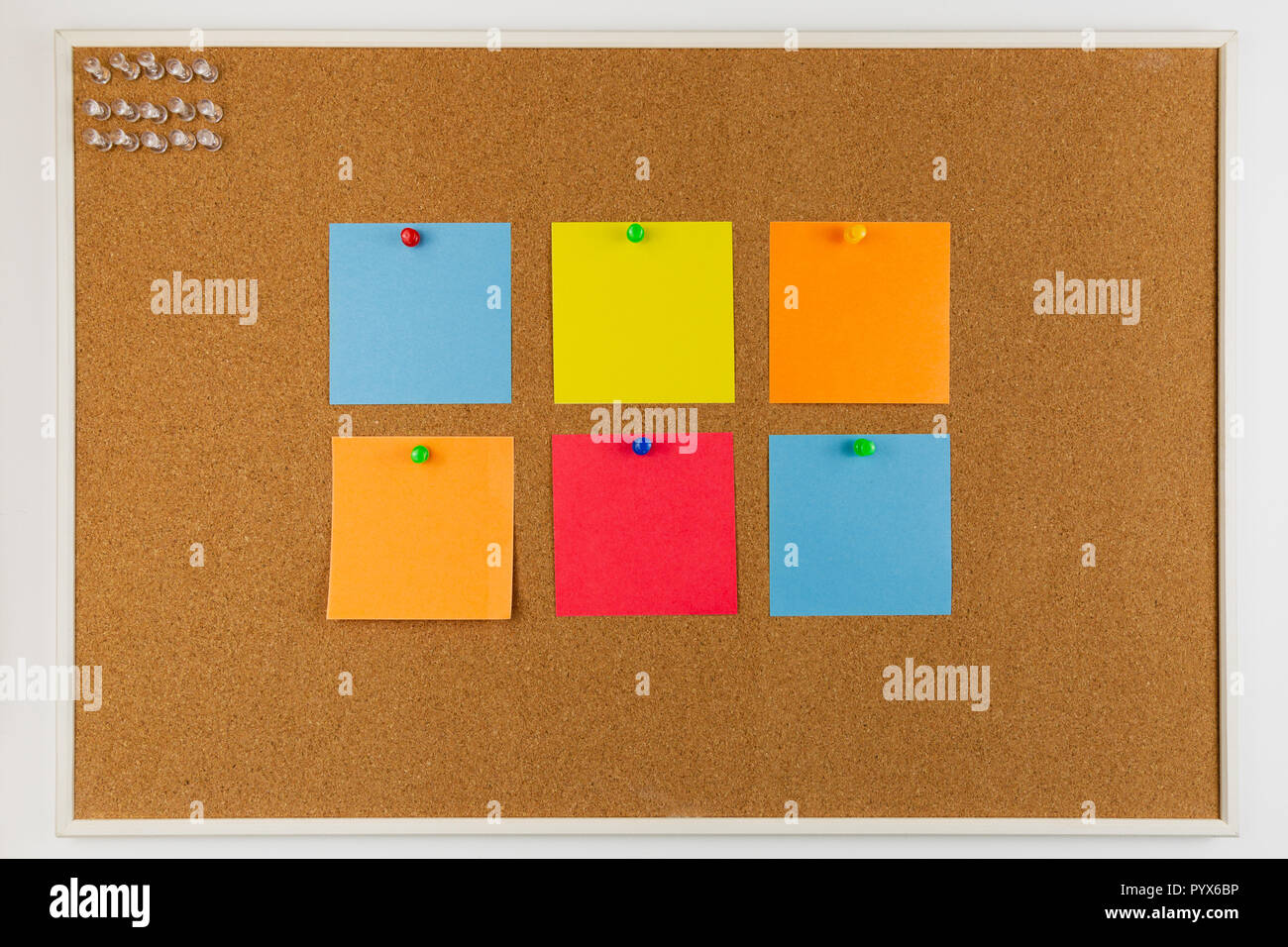 Colorful paper pined to cork board as reminders Stock Photo - Alamy