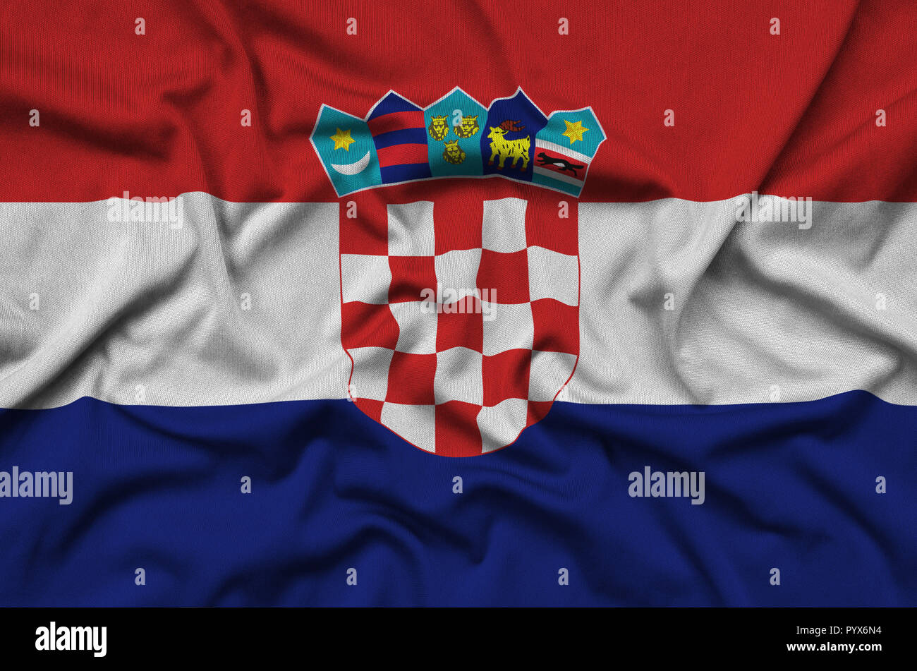 Croatia flag is depicted on a sports cloth fabric with many folds ...