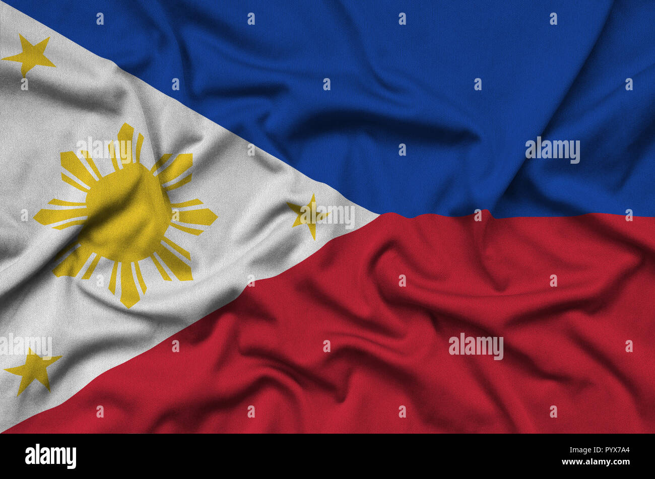 Philippines flag is depicted on a sports cloth fabric with many folds ...