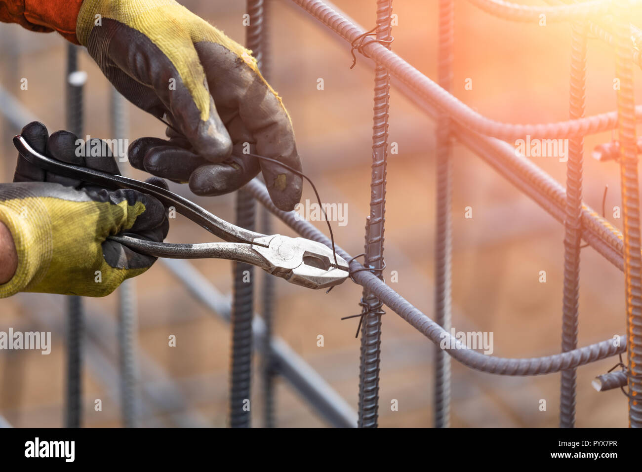 Worker Securing Steel Rebar Framing With Wire Plier Cutter Tool At ...