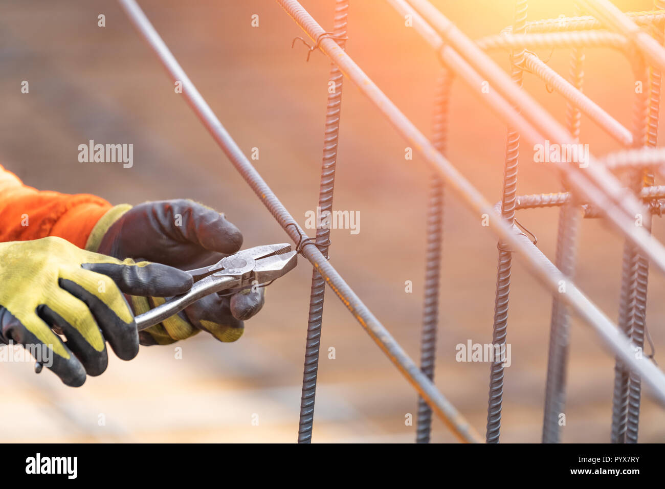 Worker Securing Steel Rebar Framing With Wire Plier Cutter Tool At ...
