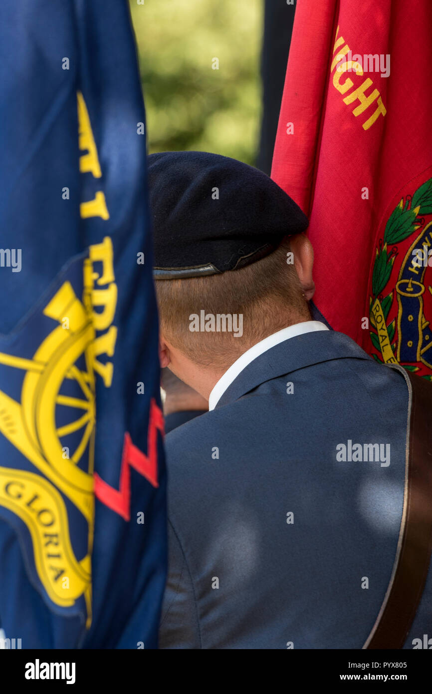an old soldier or veteran on parade standing between two banners or ...