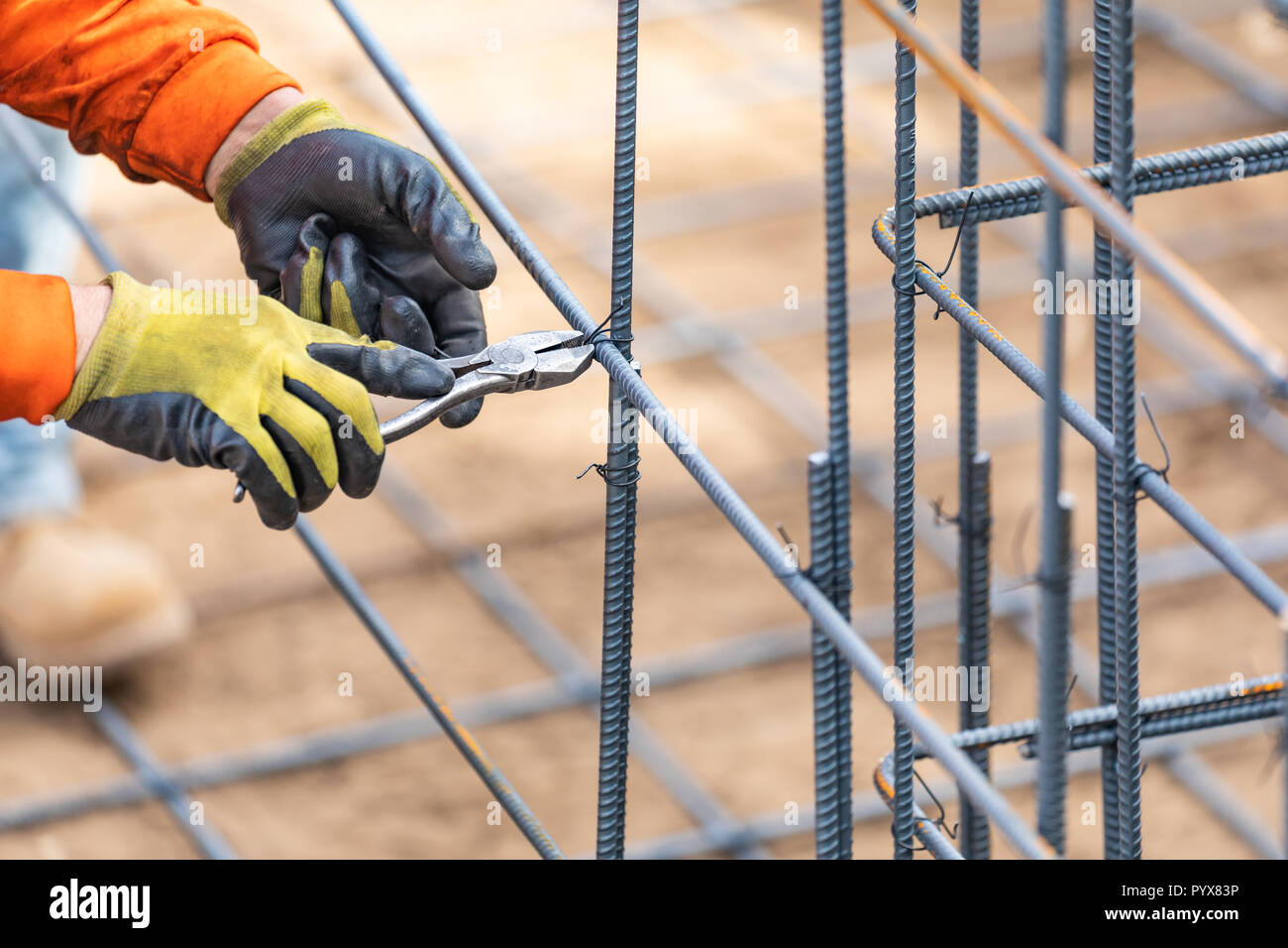 Worker Securing Steel Rebar Framing With Wire Plier Cutter Tool At ...