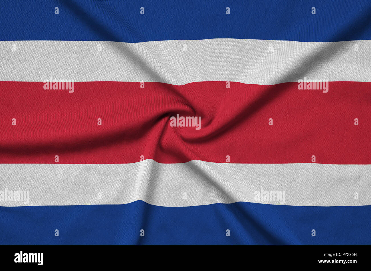 Costa Rica flag is depicted on a sports cloth fabric with many folds ...