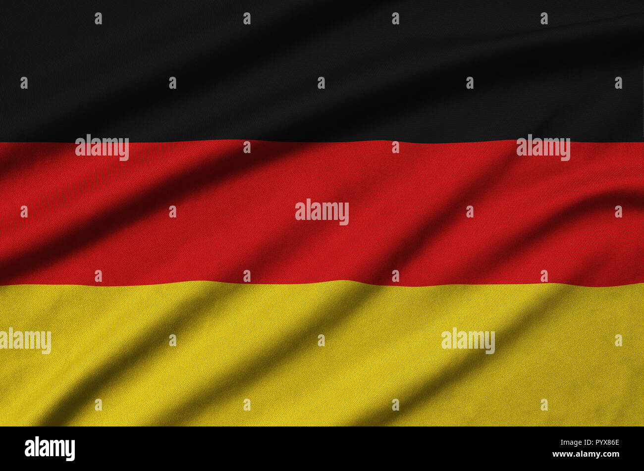 Germany flag is depicted on a sports cloth fabric with many folds ...