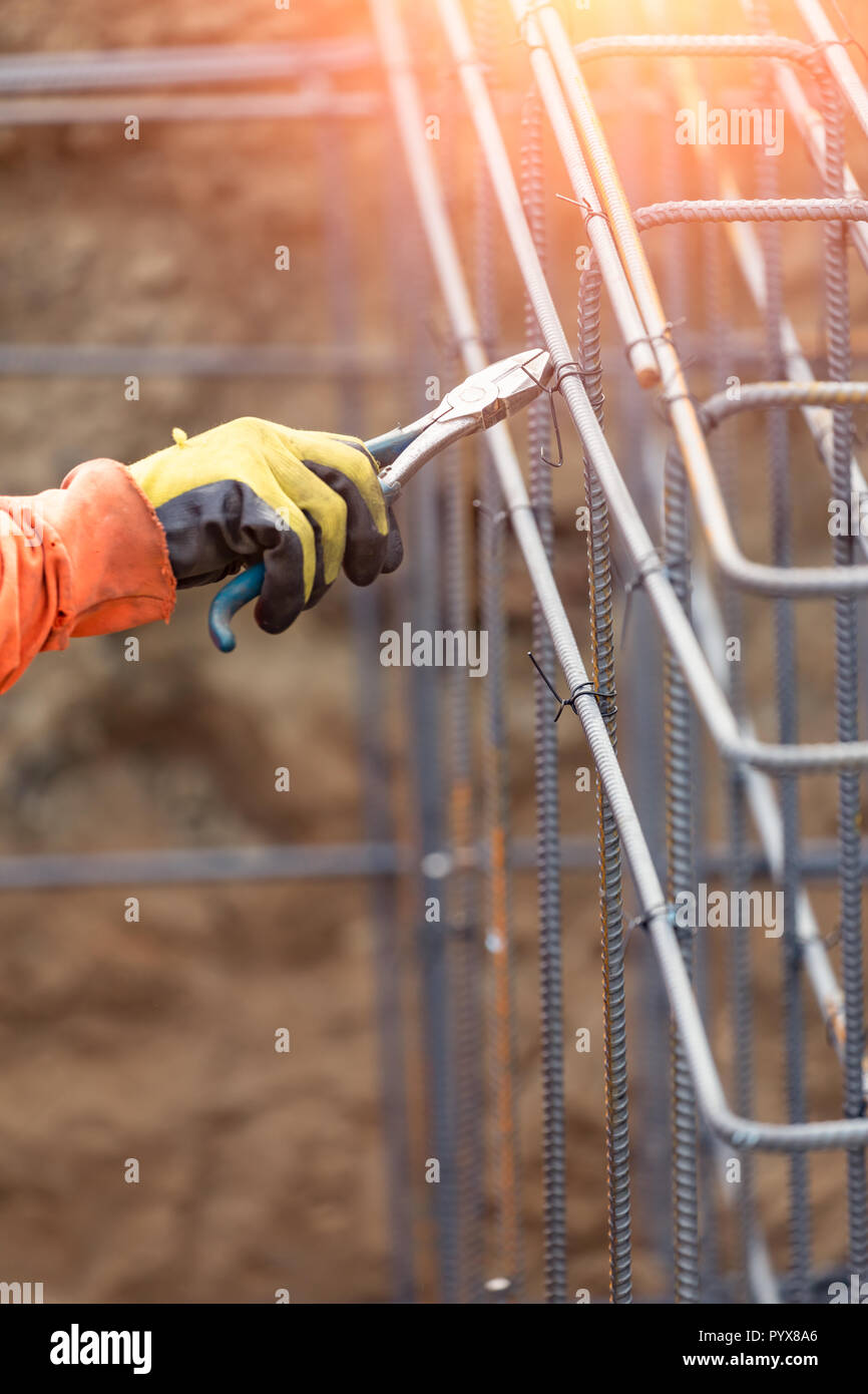 Worker Securing Steel Rebar Framing With Wire Plier Cutter Tool At ...