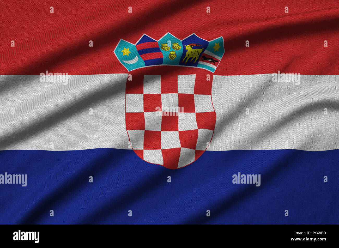 Croatia flag is depicted on a sports cloth fabric with many folds ...