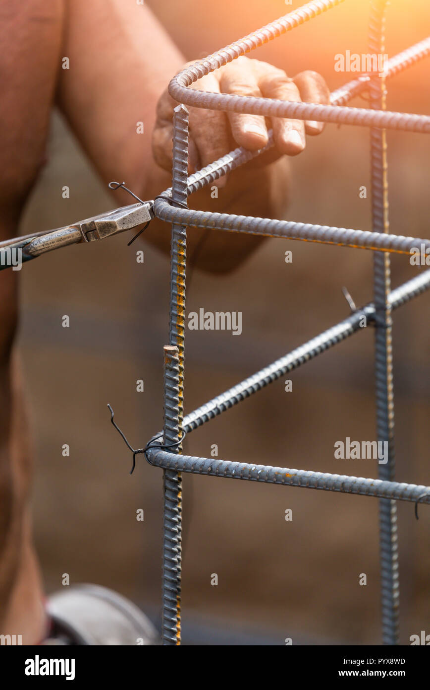 Worker Securing Steel Rebar Framing With Wire Plier Cutter Tool At ...
