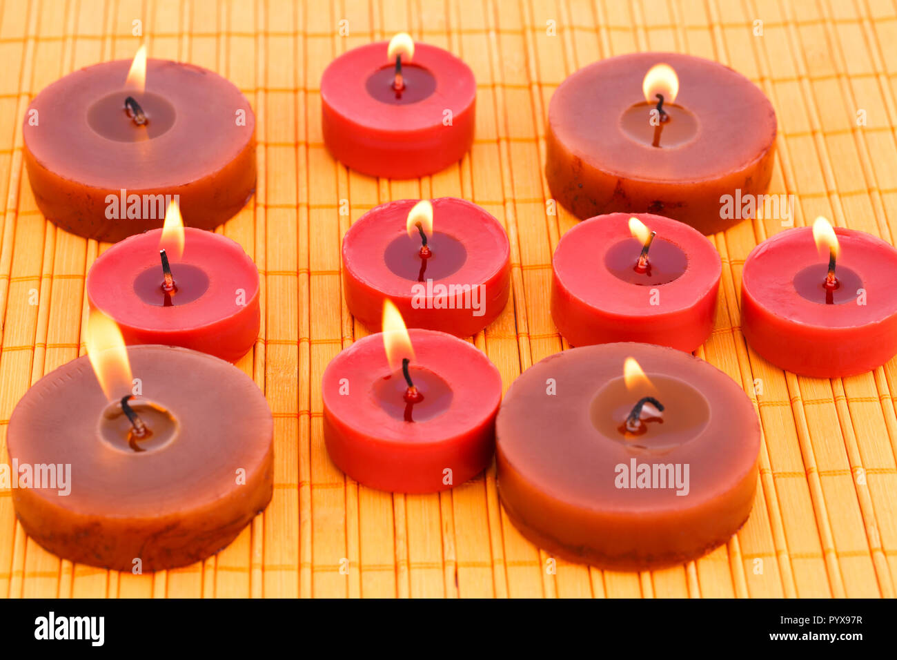Many candles on bamboo mat background Stock Photo - Alamy
