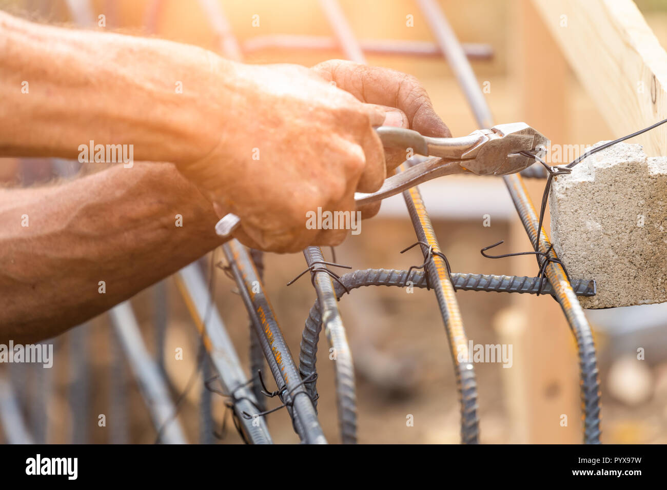 Worker Securing Steel Rebar Framing With Wire Plier Cutter Tool At ...