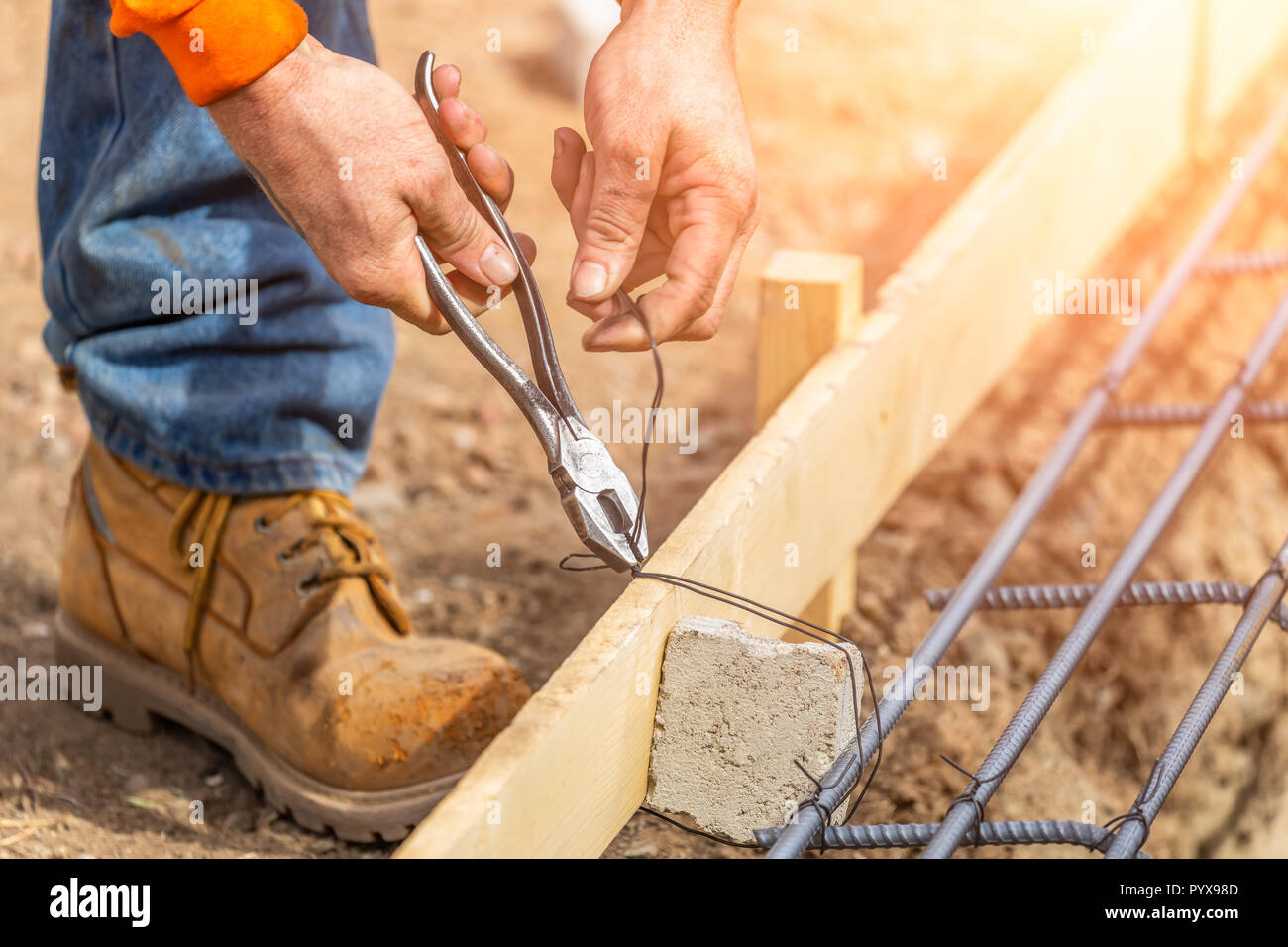 Worker Securing Steel Rebar Framing With Wire Plier Cutter Tool At ...