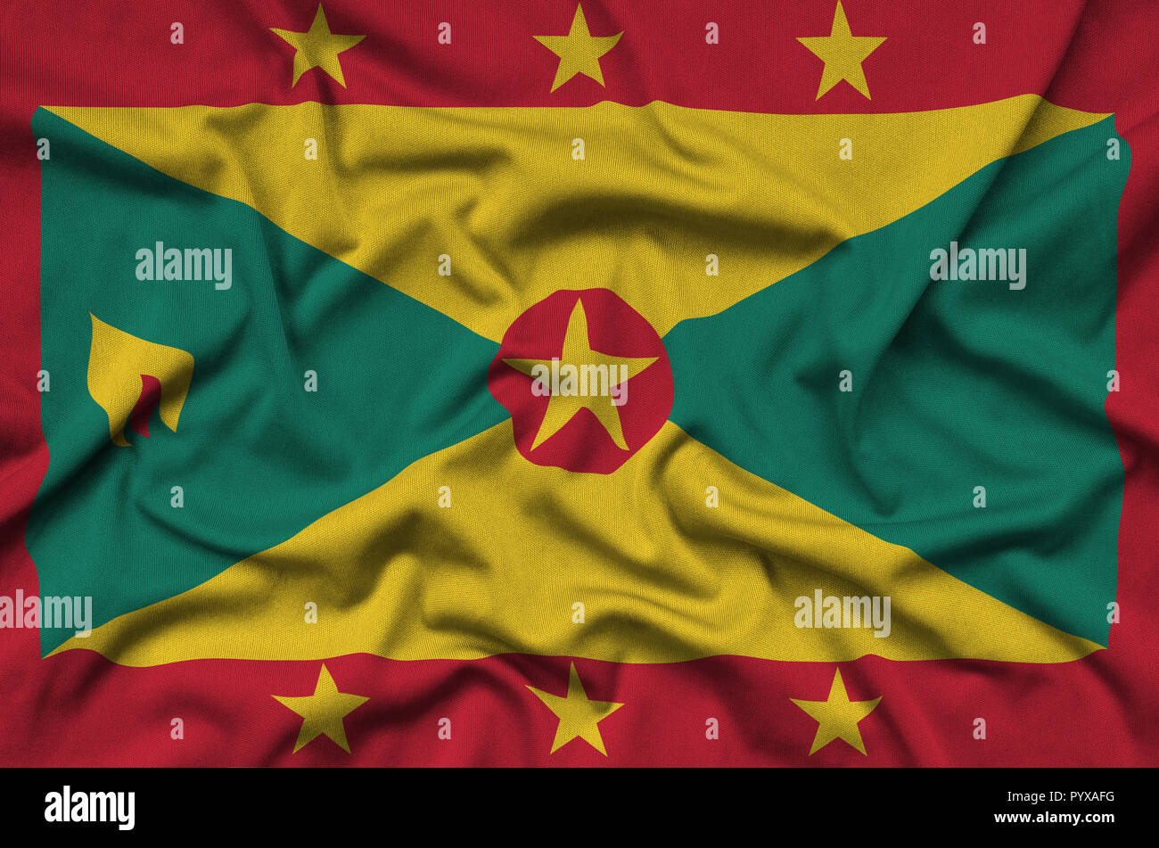 Grenada flag is depicted on a sports cloth fabric with many folds ...