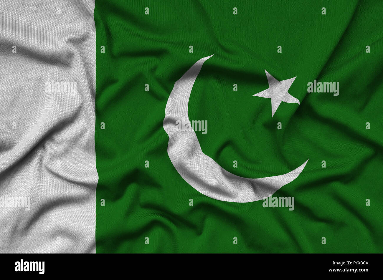 Pakistan flag is depicted on a sports cloth fabric with many folds ...