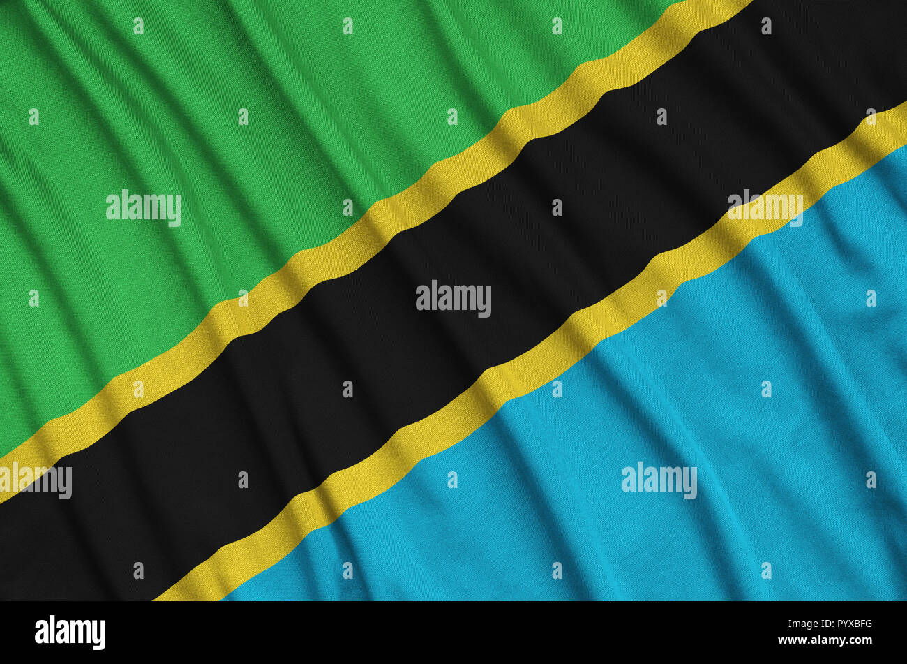 Tanzania flag is depicted on a sports cloth fabric with many folds ...