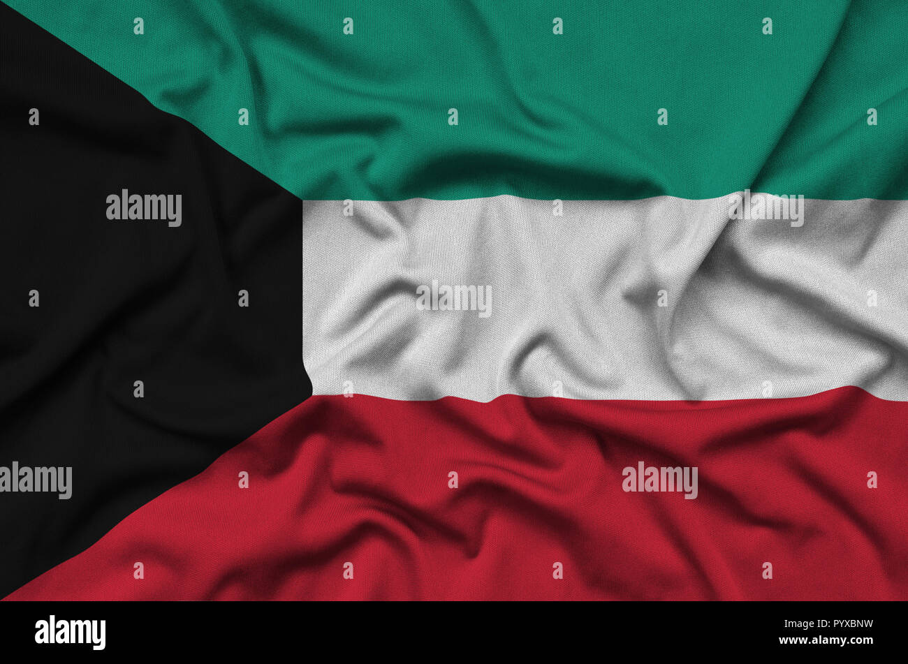 Kuwait flag is depicted on a sports cloth fabric with many folds. Sport ...