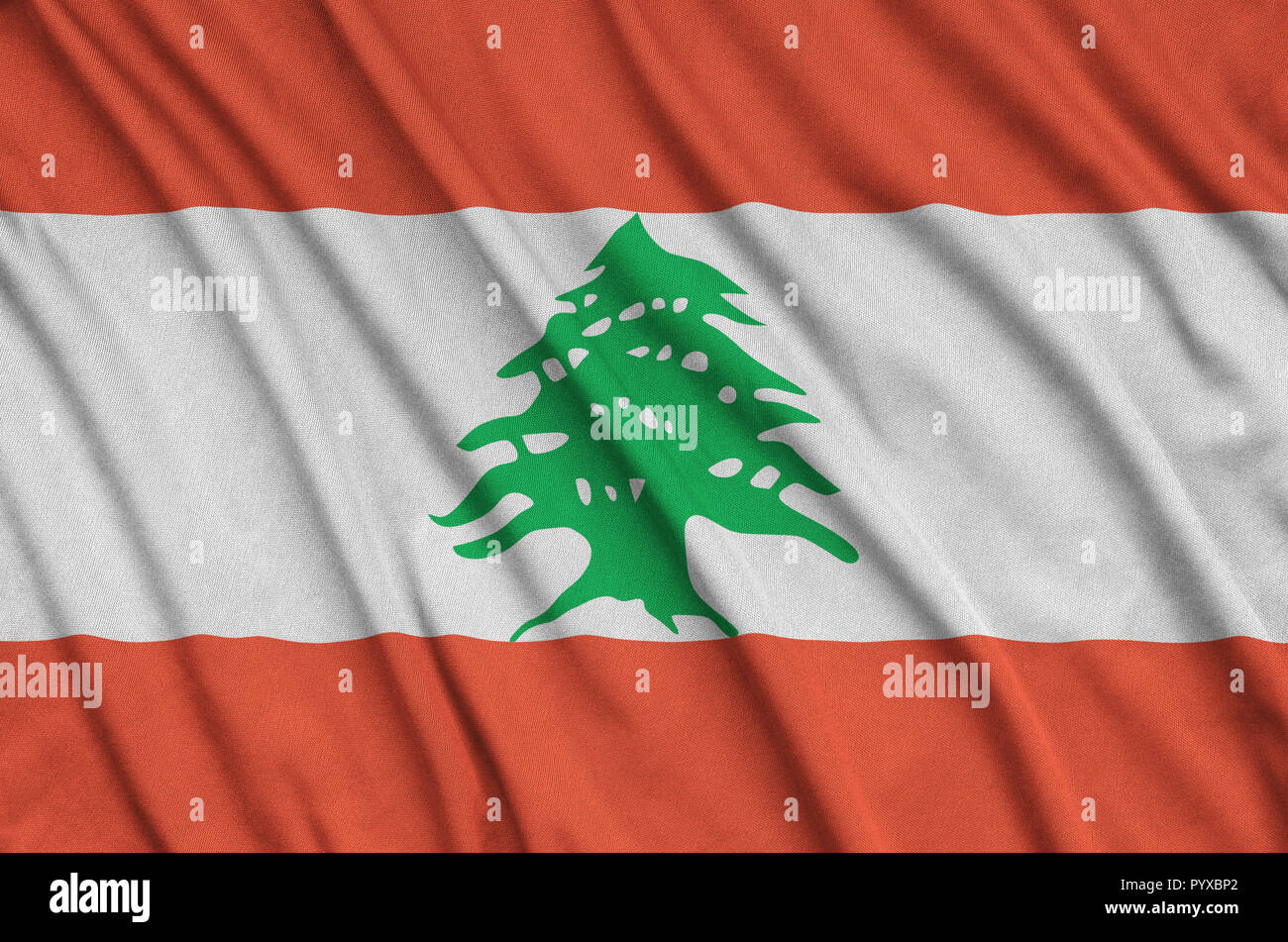 Lebanon flag is depicted on a sports cloth fabric with many folds ...