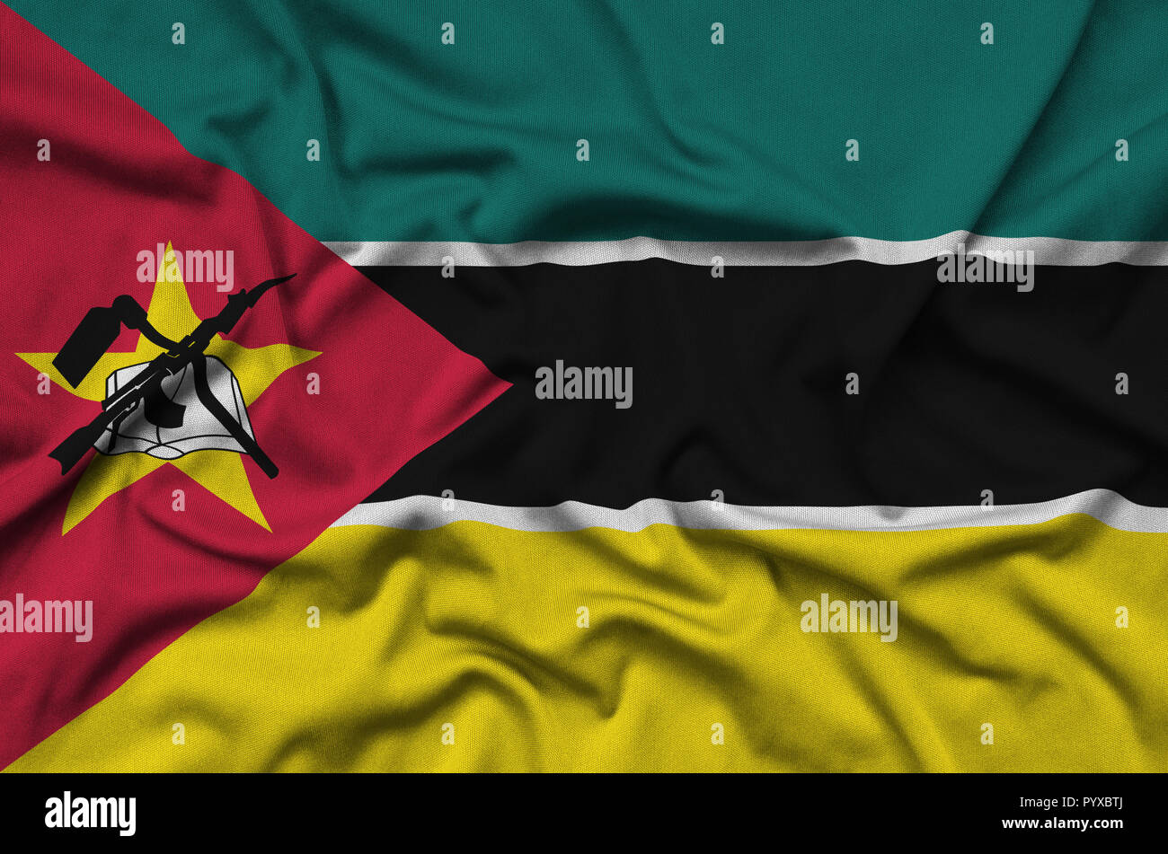 Mozambique flag is depicted on a sports cloth fabric with many folds ...