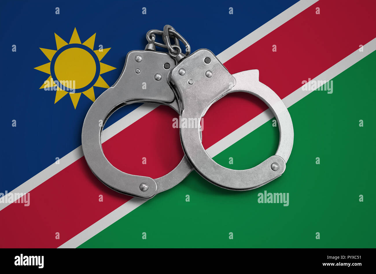 Namibia flag and police handcuffs. The concept of observance of the law ...
