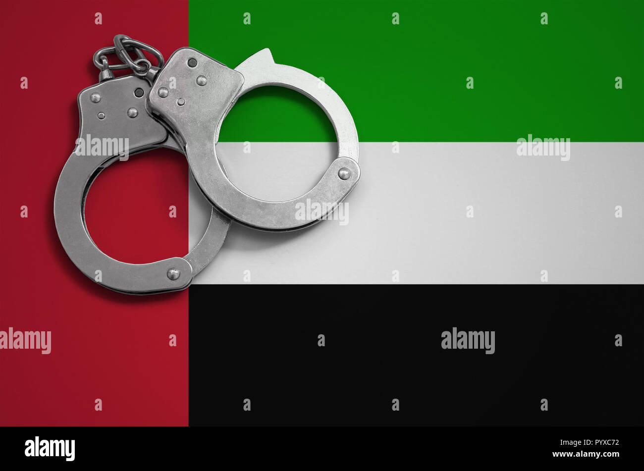 United Arab Emirates flag and police handcuffs. The concept of crime ...
