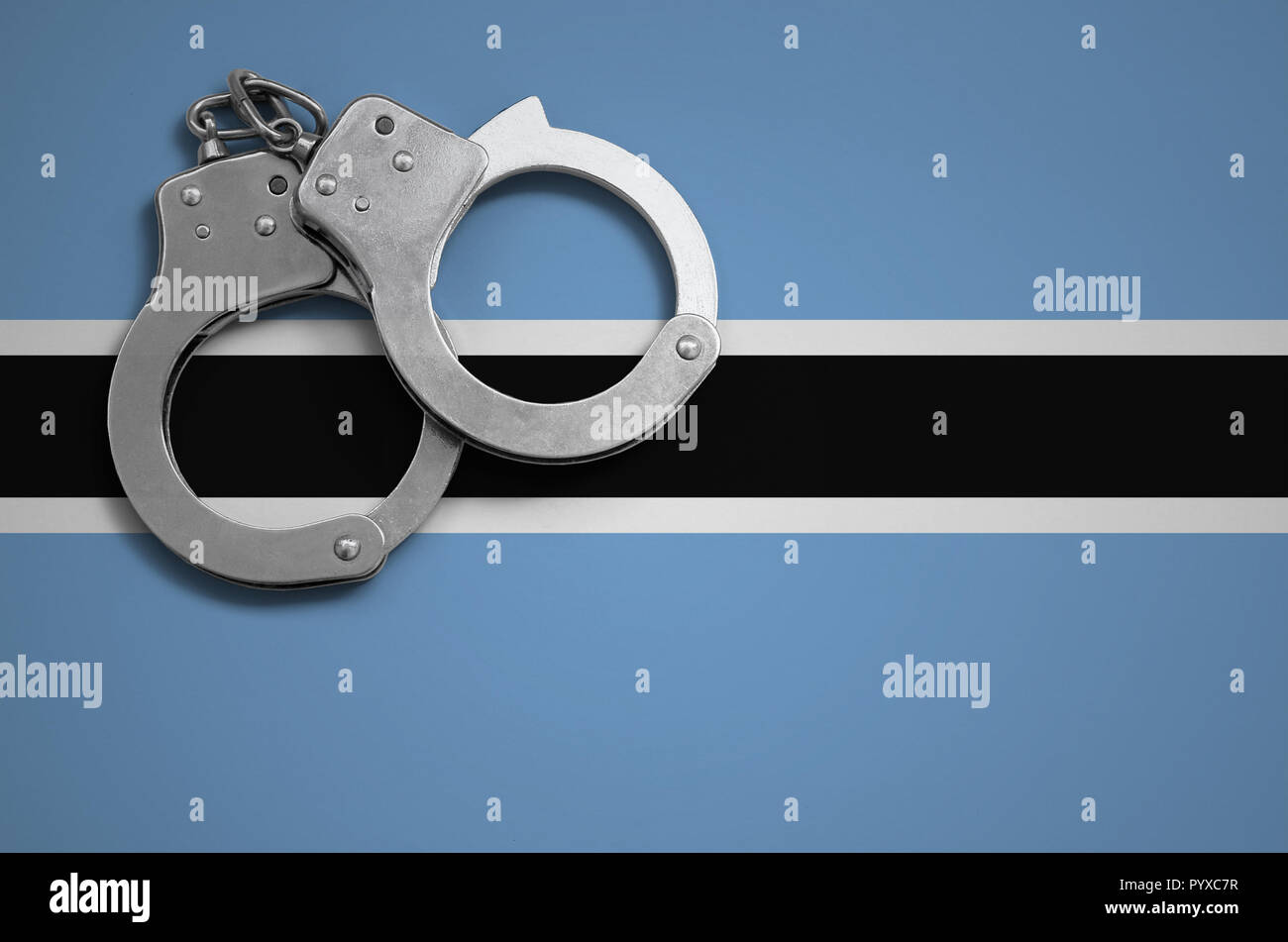 Botswana flag and police handcuffs. The concept of crime and offenses ...