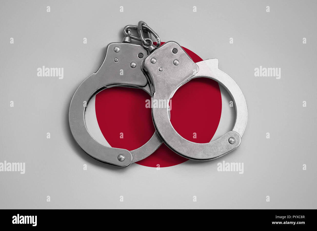 Japan flag and police handcuffs. The concept of observance of the law ...