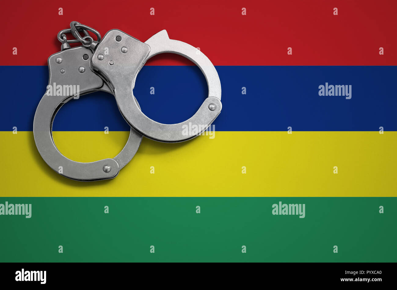 Mauritius flag and police handcuffs. The concept of crime and offenses ...