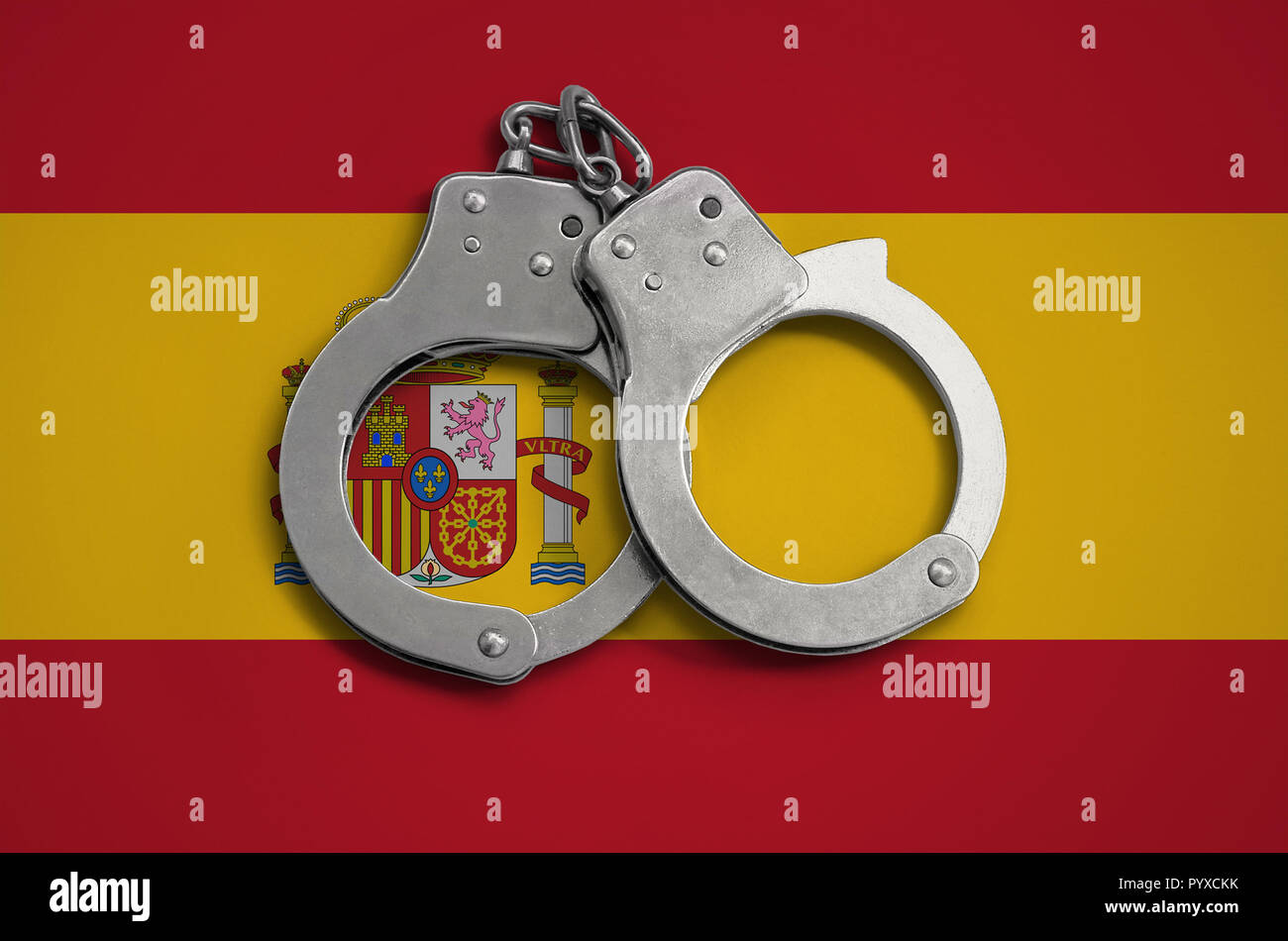 Spain flag and police handcuffs. The concept of observance of the law ...