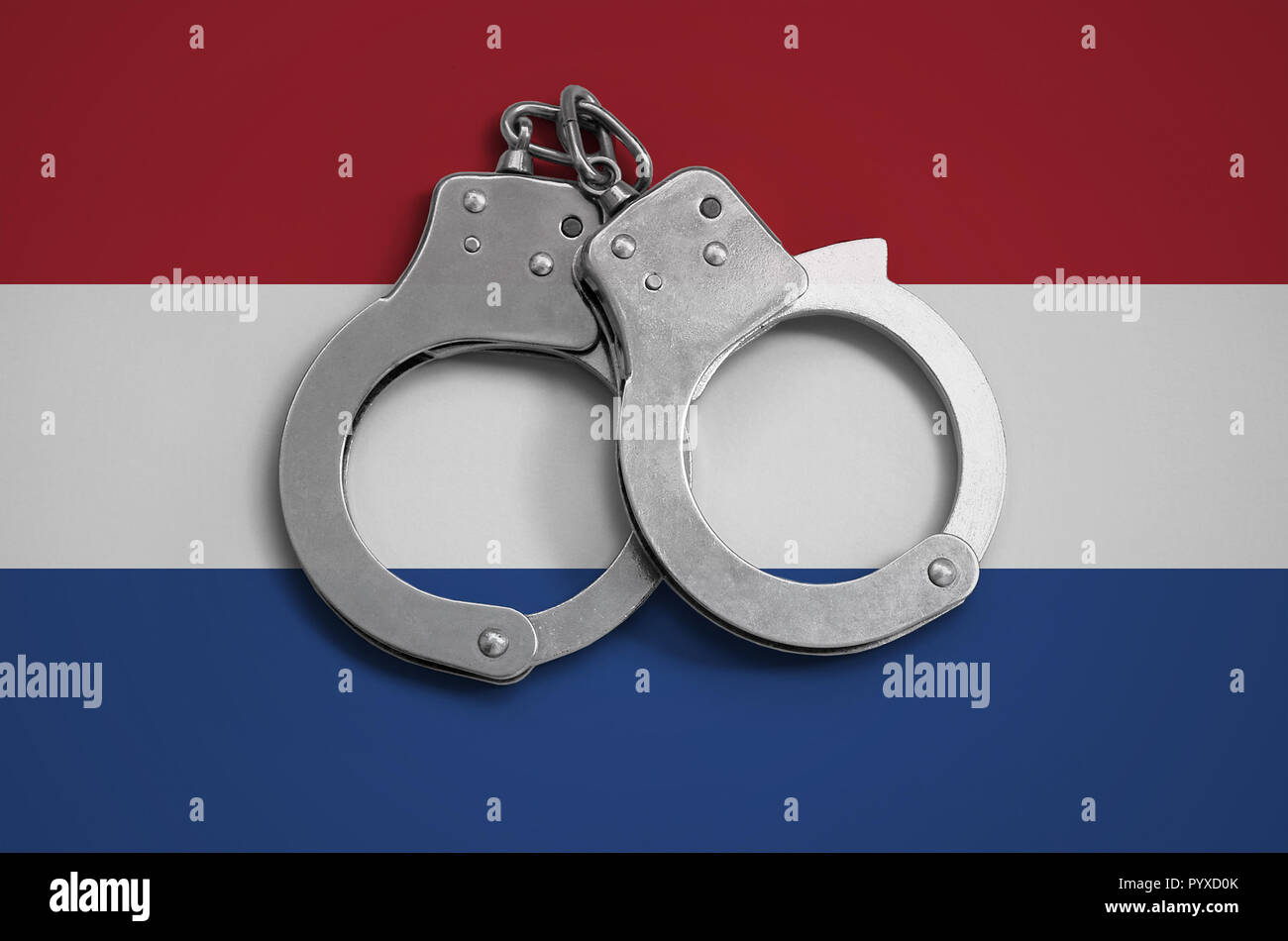 Netherlands flag and police handcuffs. The concept of observance of the ...