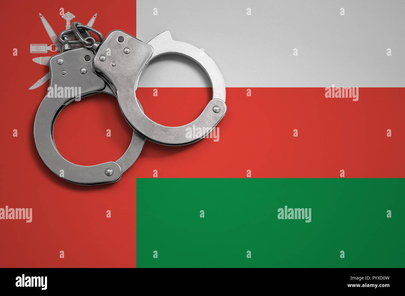 Oman flag and police handcuffs. The concept of crime and offenses in ...