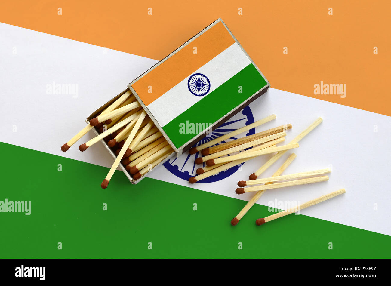 India flag is shown on an open matchbox, from which several matches ...