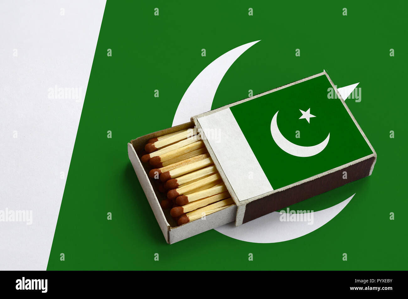 Pakistan flag is shown in an open matchbox, which is filled with ...