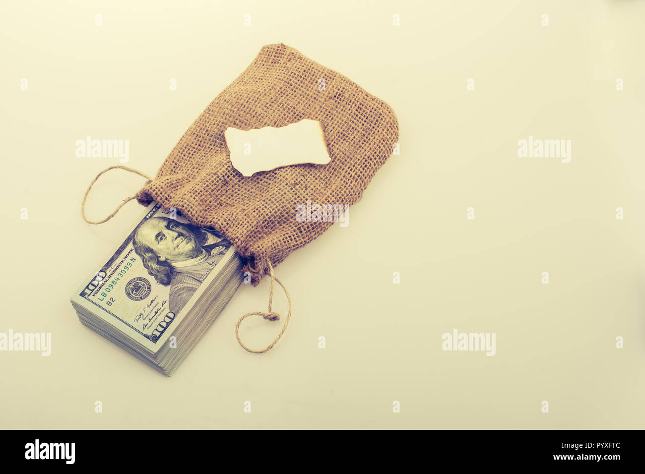 Banknote bundle of US dollarin a sack with a note paper Stock Photo - Alamy