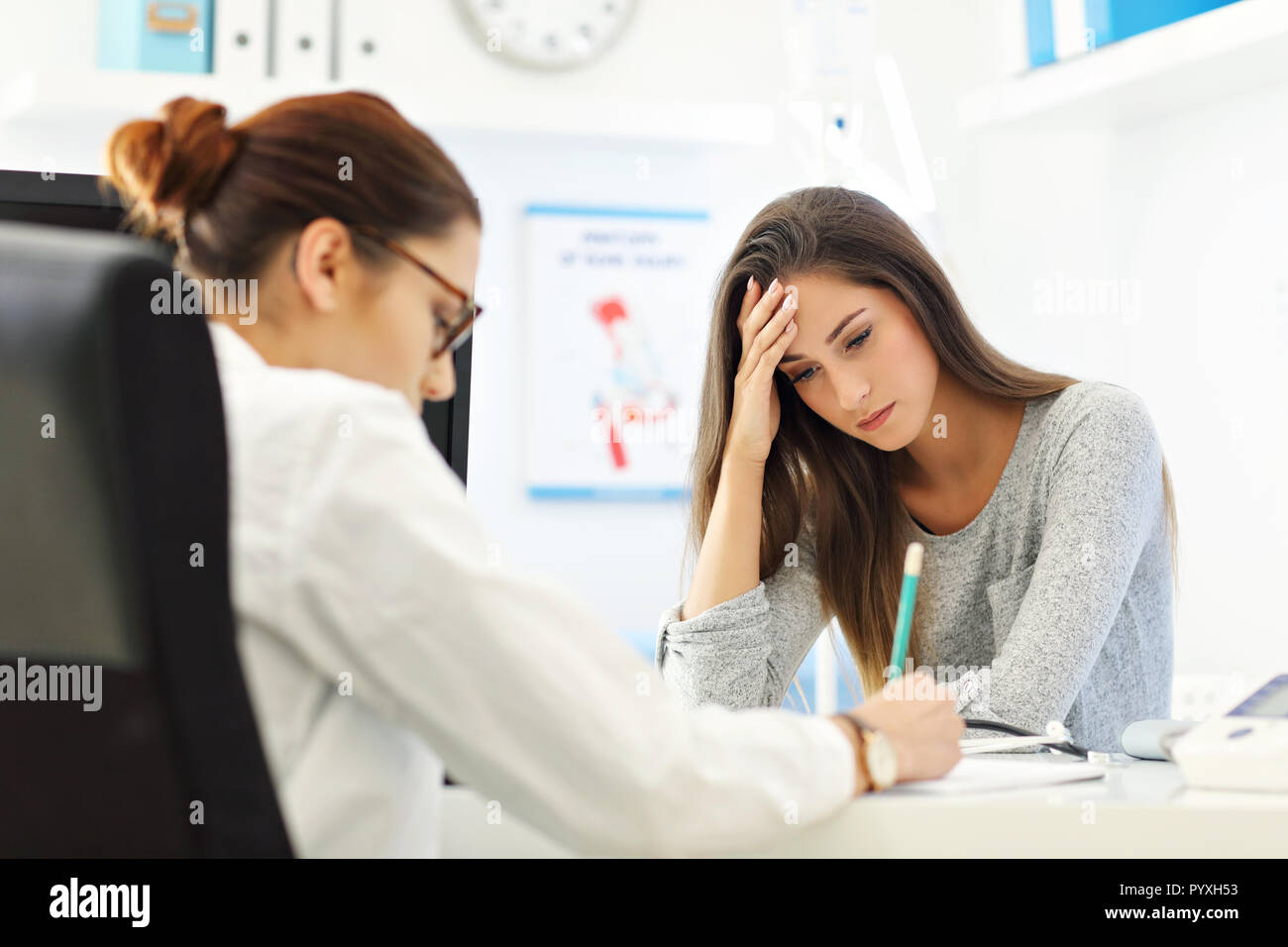 Picture of adult woman having a visit at female doctor's office Stock ...