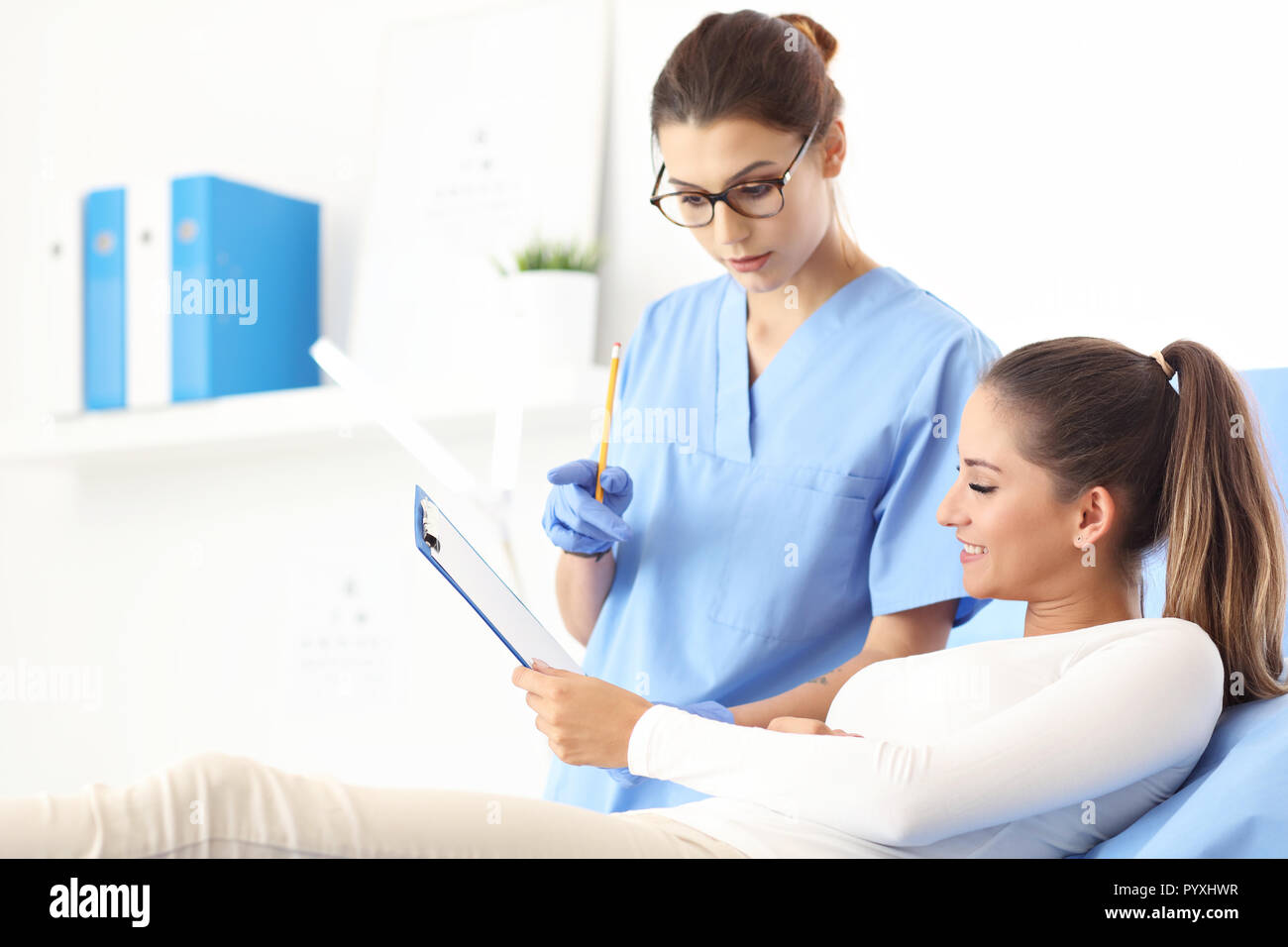 Picture of adult woman having a visit at female doctor's office Stock ...
