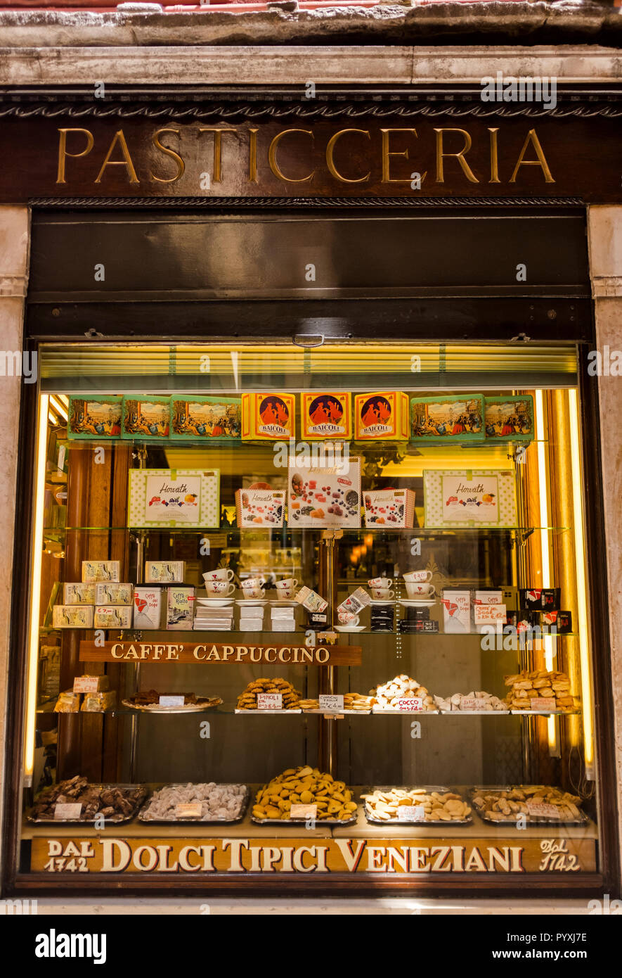 The window of a pasticceria showcases fresh pastries and sweets for ...