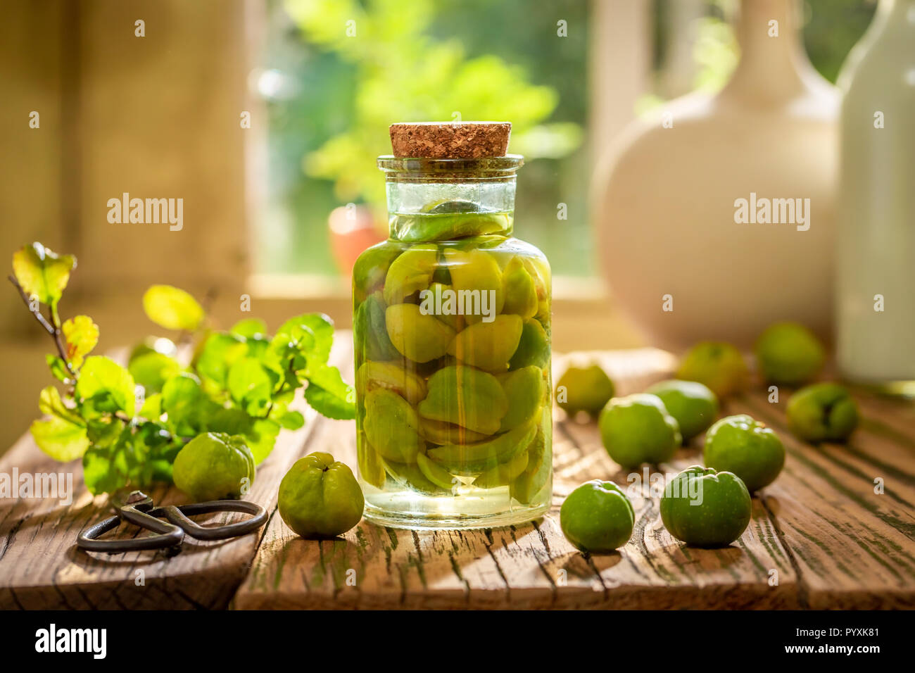 Sweet quince tincture made of fruits and alcohol Stock Photo - Alamy