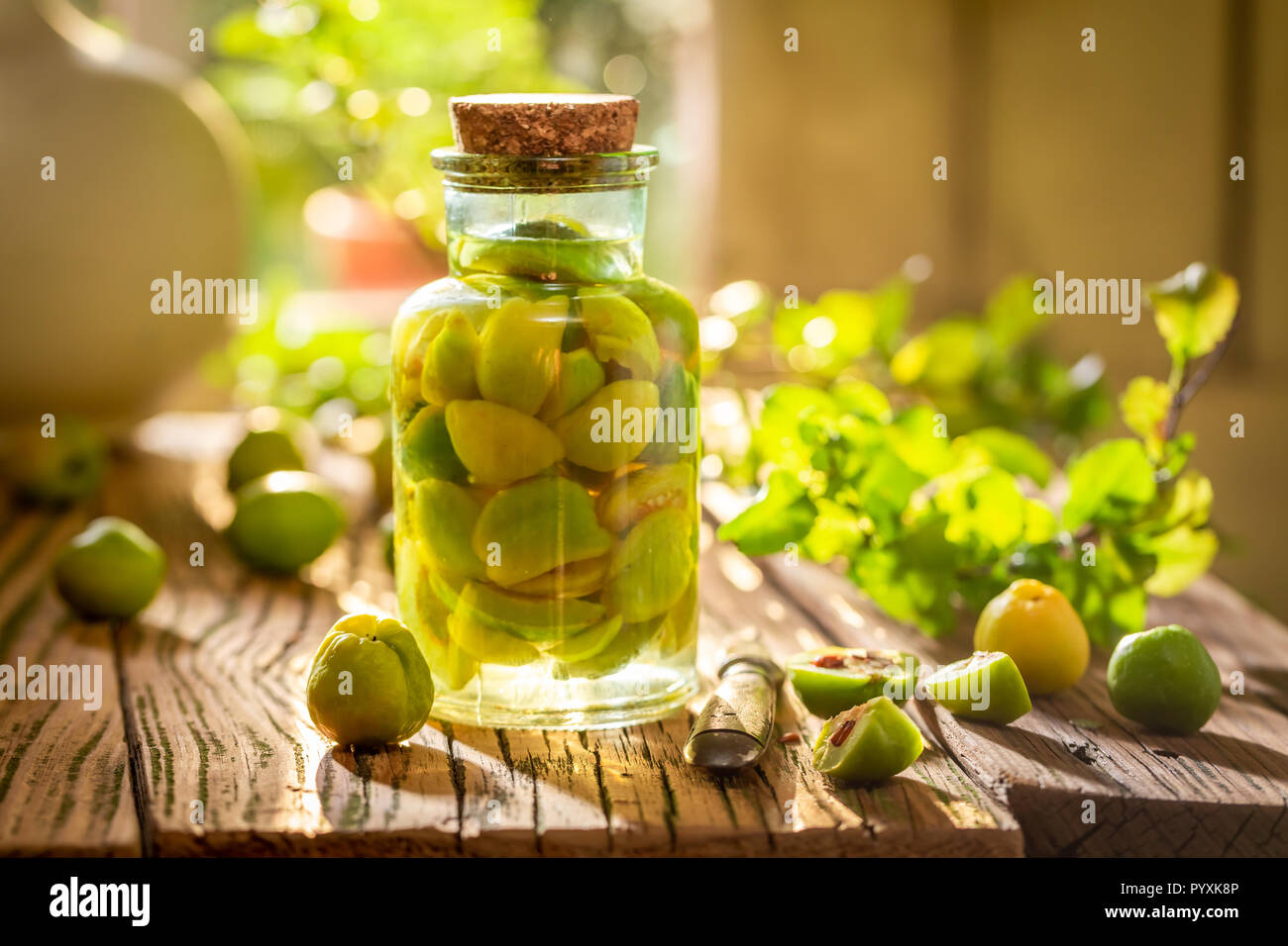 Strong quince tincture made of fruits and alcohol Stock Photo - Alamy