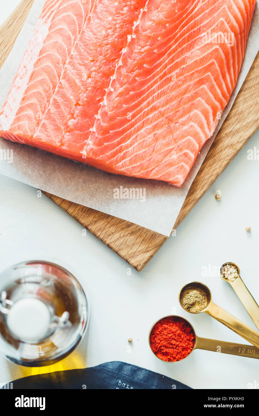 Fresh salmon fillets on a kitchen table for preparing recipe with ...
