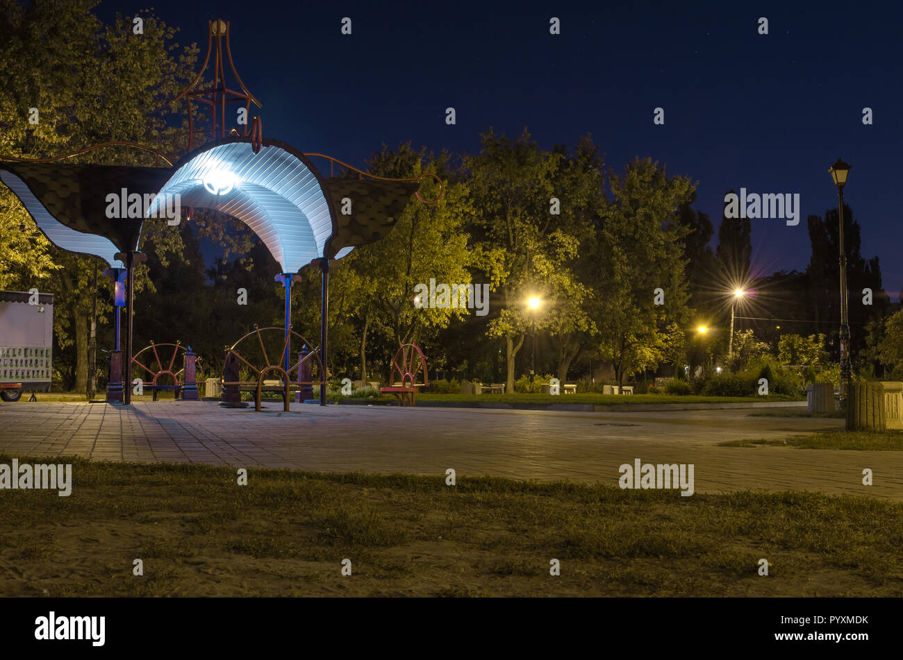 Night park landscape with well and glowing lanterns Stock Photo - Alamy
