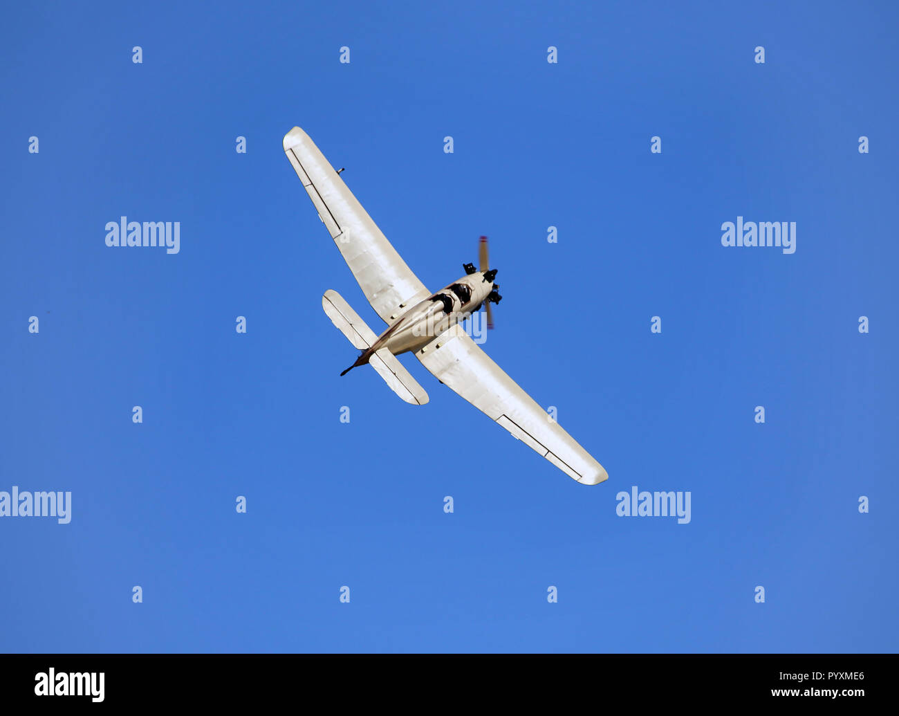 Retro piston sport airplane with propeller in flight on the background ...