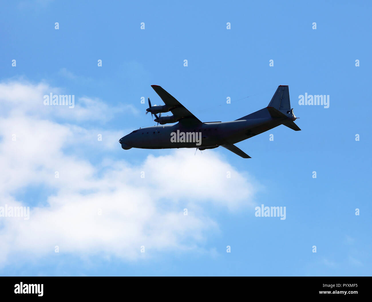 Four-engine military transport aircraft in flight in cloudy sky Stock ...