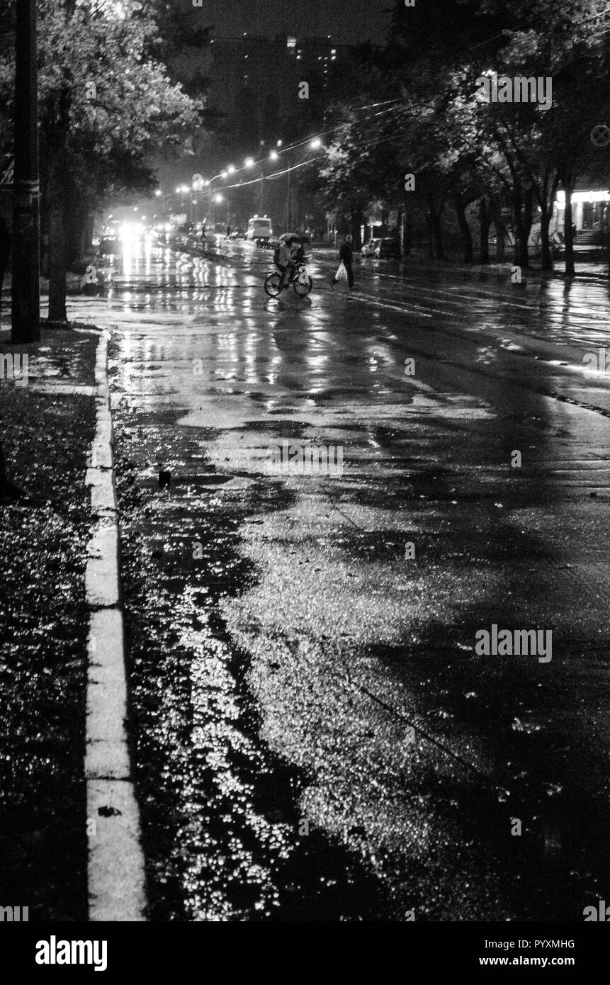 The night city road traffic under rain Stock Photo - Alamy