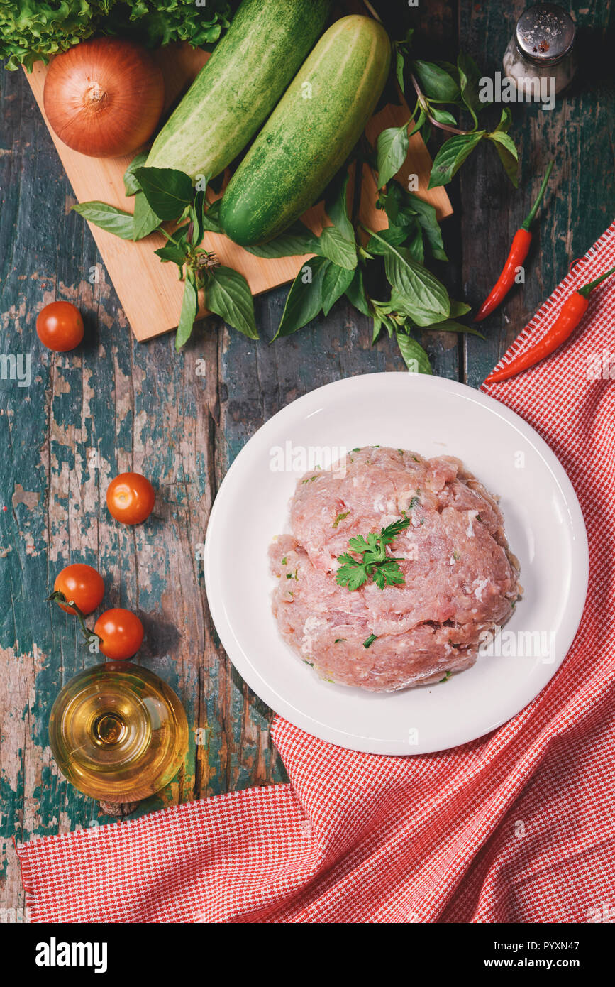 Homemade food. Raw fish on plate in the kitchen with vegetables Stock ...