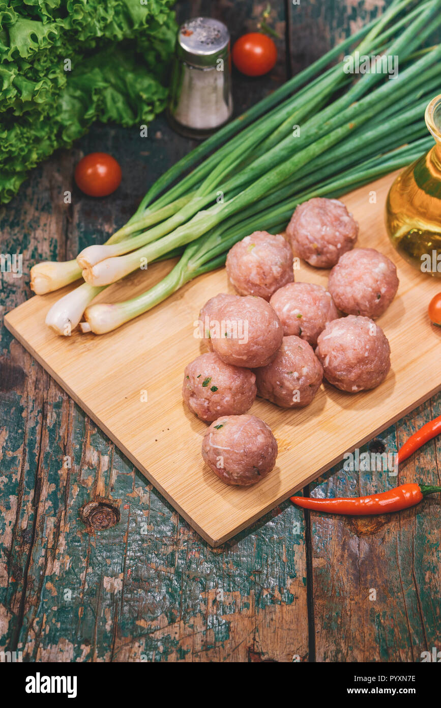 Homemade food. Raw fish ball (uncooked) in the kitchen with vegetables ...