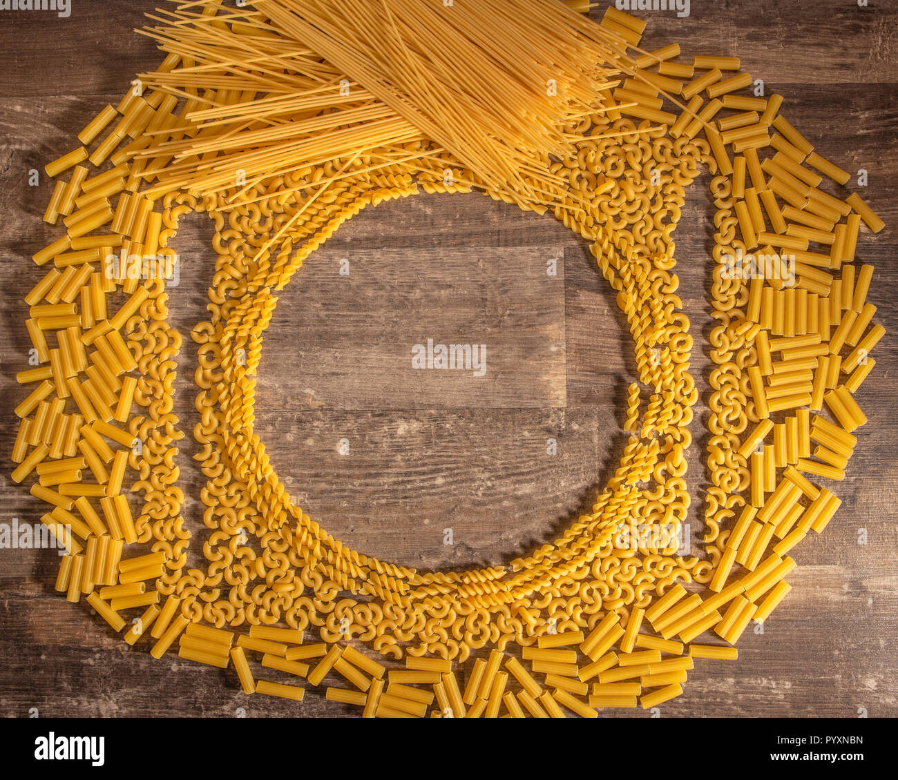 different kinds of pasta in circular layers with empty space in the ...
