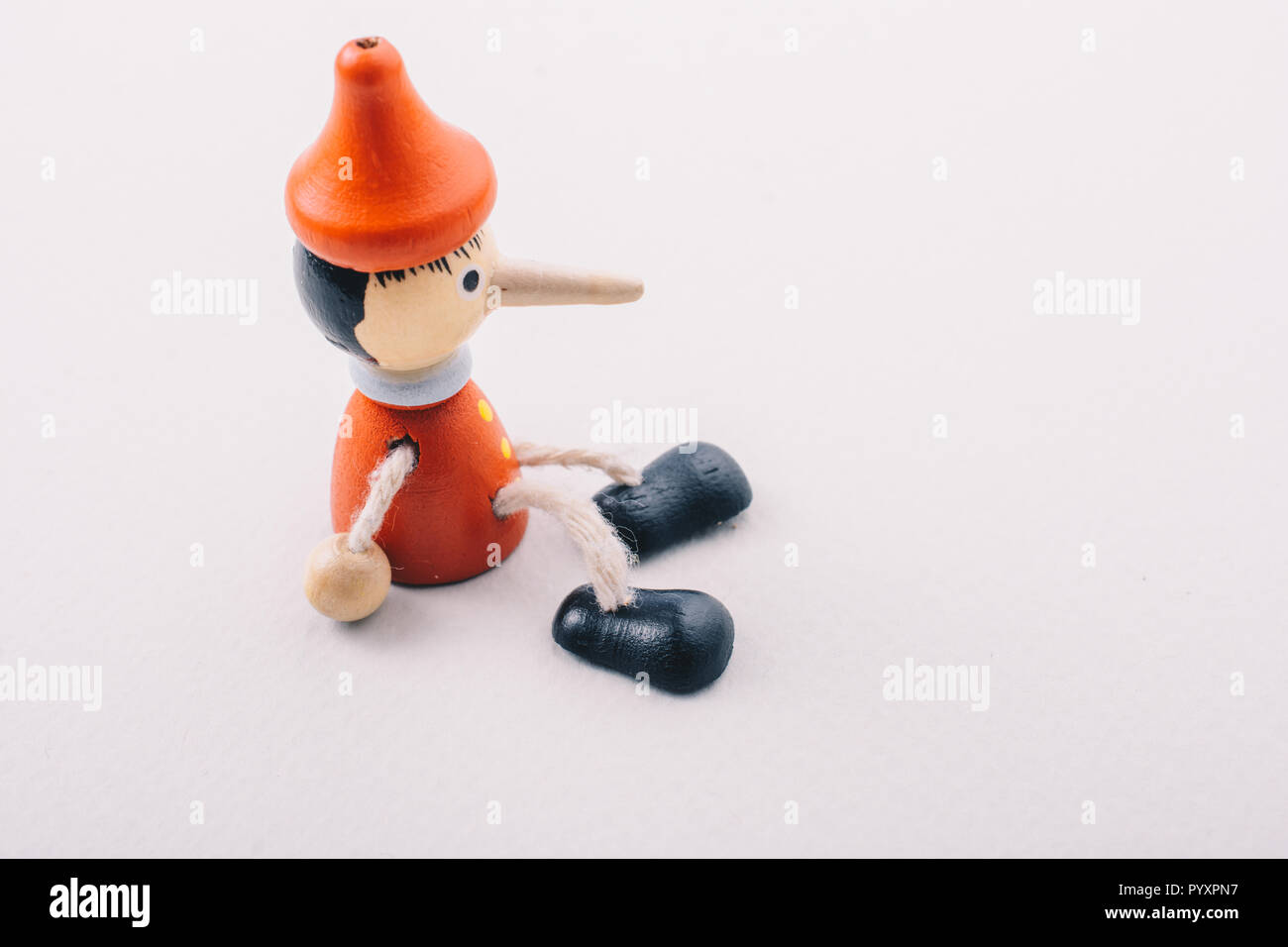 Wooden pinocchio doll with his long nose on a white background Stock ...
