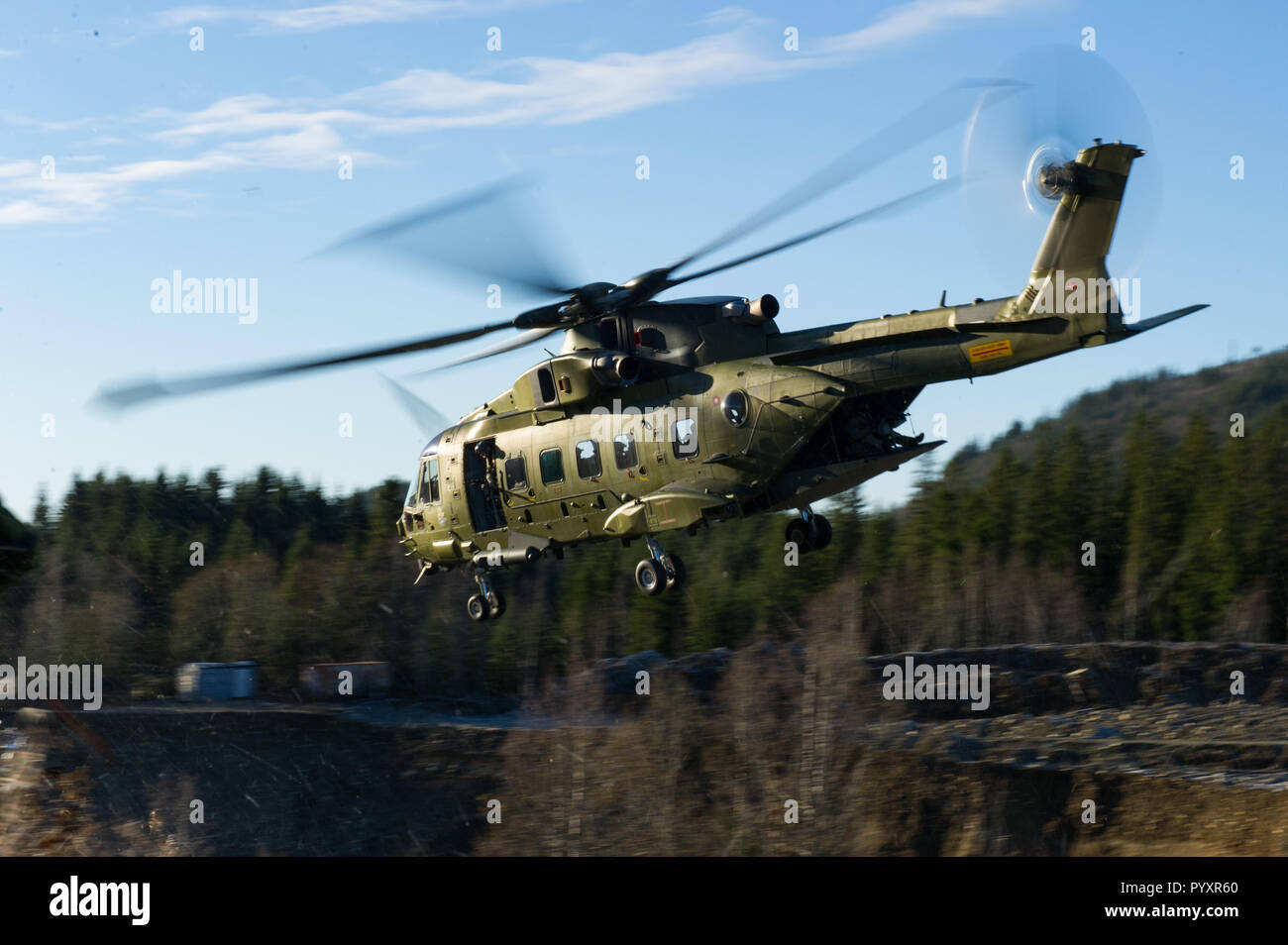 A Danish AW101-Merlin helicopter flies overt Camp Fremo during Exercise ...