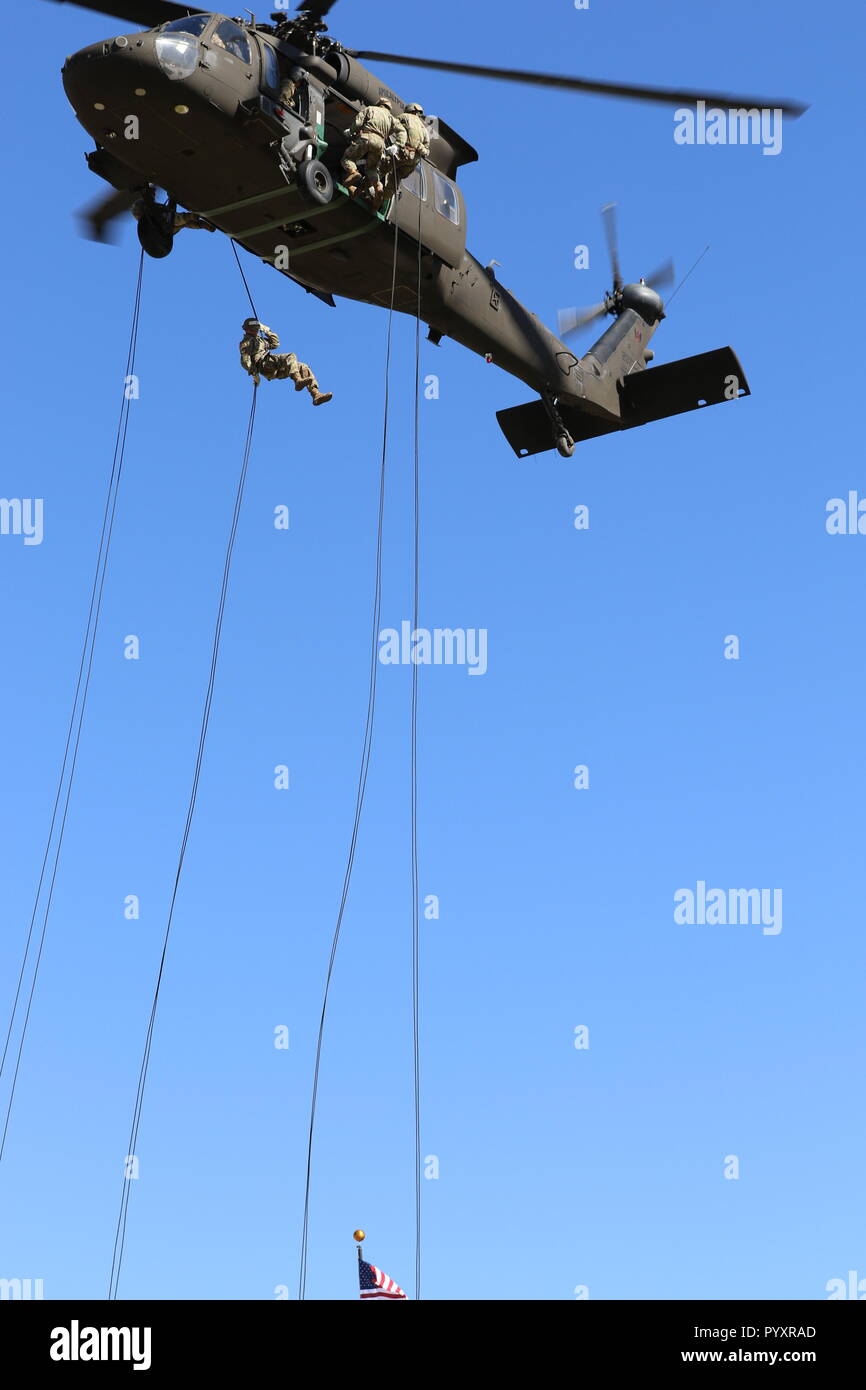 Soldiers rappel from a UH-60 Black Hawk helicopter during the air ...