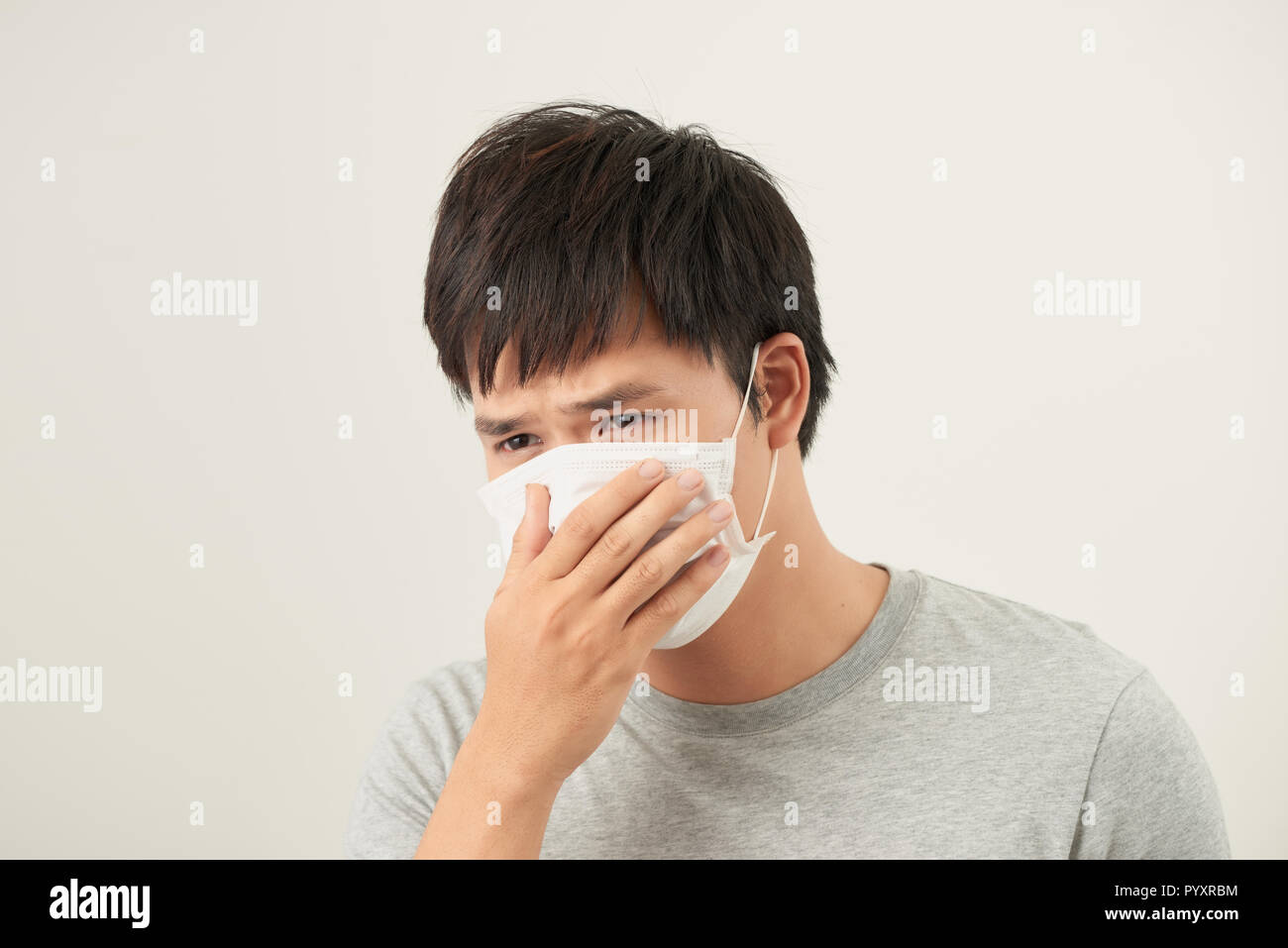 Asian man wearing a face mask with coughing Stock Photo - Alamy